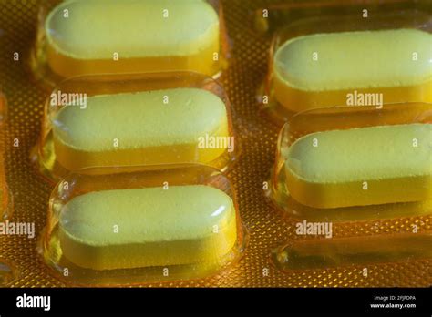 Drug Tablets In Yellow Color Macro Photography Stock Photo Alamy