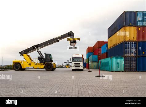Truck While Loading In Logistic Shipping Yard With Cargo Container Forklift Truck Handling