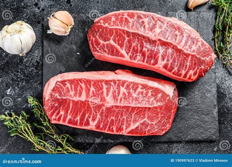 The Top Blade Steak Or Beef Steak With Herbs And Spices On White