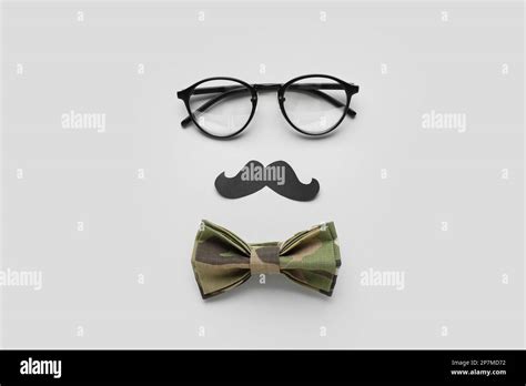 Composition With Eyeglasses Paper Mustache And Bow Tie On White