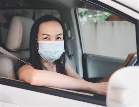 Beautiful Asian Woman Wearing Medical Face Mask While Driving Car