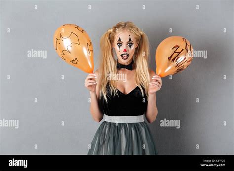 Excited Crazy Blonde Woman In Clown Make Up Holding Halloween Balloon