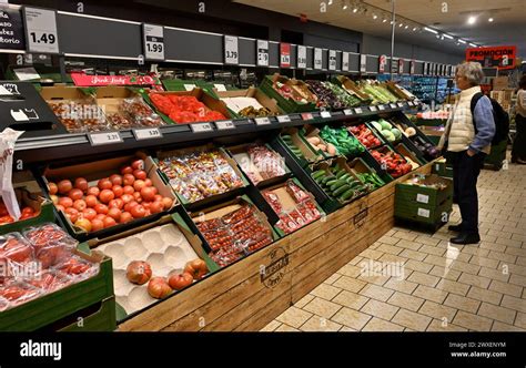 Fruit And Vegetables On Shelves In Lidl Supermarket With Customer Stock