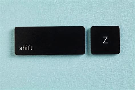Premium Photo Shift Key And Z Key Detached From Keyboard On Blue