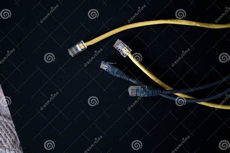 Ethernet Cables With Gold Plated Connectors Rest On A Dark Surface