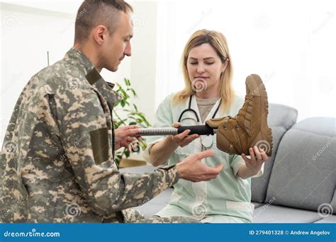 Portrait Of Military Veteran Fixing Prosthetic Leg And Wearing Army