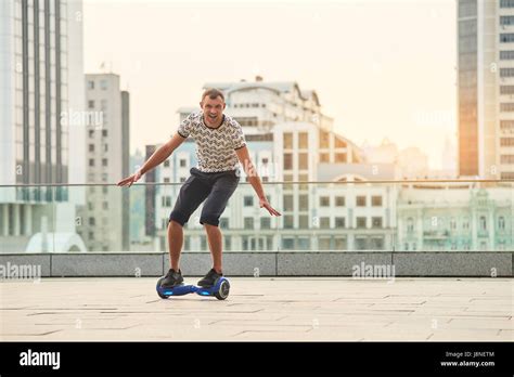 Guy Riding Hoverboard City Background Stock Photo Alamy