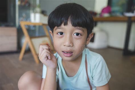 Close Up Portrait Of Asian Boy With Black Bangs Black Eyes With A