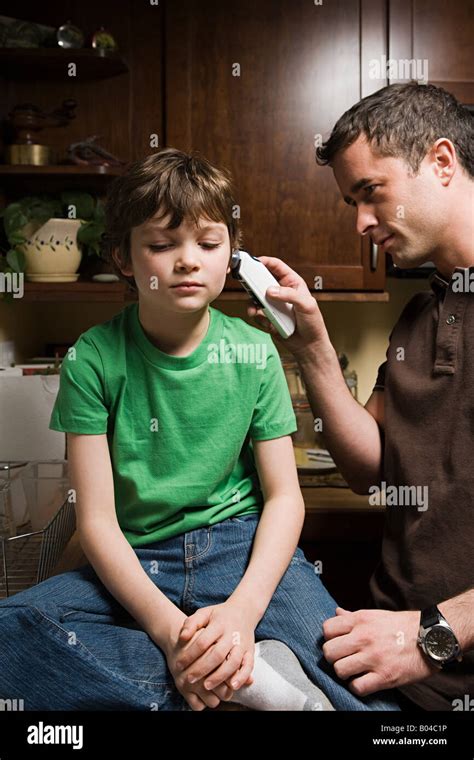 A Father Checking His Sons Temperature Stock Photo Alamy