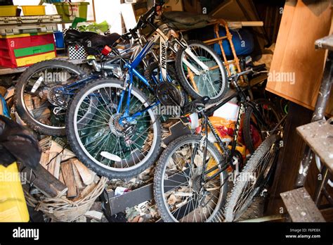 Inside A Messy And Cluttered Wooden Garage Shed With Tools Bikes And