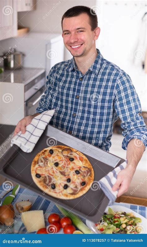 Young Smiling Happy Man Posing With Delicious Pizza In Kitchen A Stock