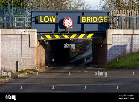 Low Bridge Warning Sign With Height Restriction Information For