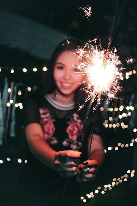 Free Photo Woman Holding Firecrackers Blur Sparks Sparkler Free
