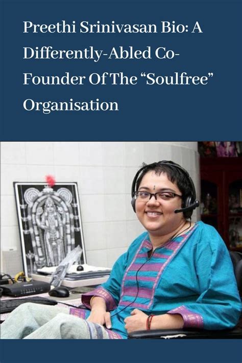 A Woman With Headphones On Sitting In Front Of A Computer Desk And