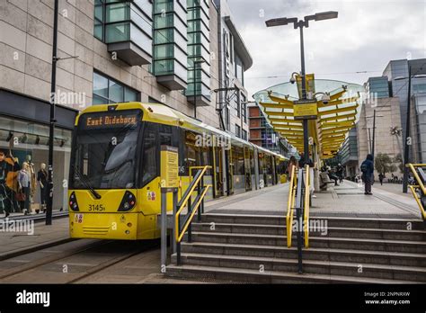 A Yellow And Grey Metrolink Tram Stopping At Corporation Street In