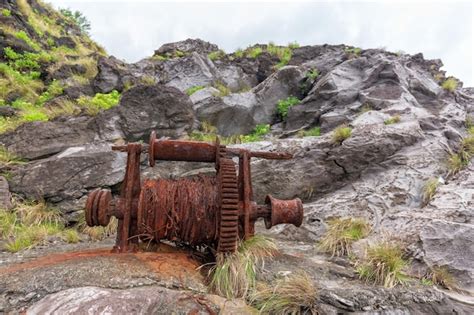 Premium Photo Rusty Metallic Structure On Rocks