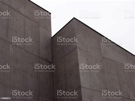 Angular Stark Concrete Walls With Corners And White Sky With Rectangualr Panels And Regular