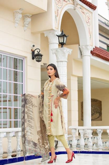 Premium Photo Stylish Girl Side Pose Outside Modern House Wearing