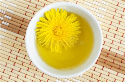 Small White Bowl With Cosmetic Cleansing Oil And Dandelion Flower