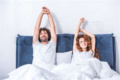 Beautiful Happy Young Couple Waking Up Together In Bed Stock Image