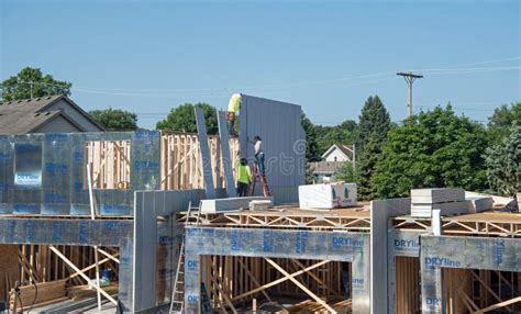 Construction Workers Installing Second Story Condominium Firewall