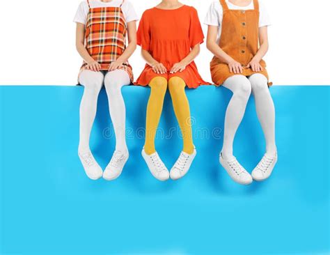 Group Of Women Wearing Colorful Tights And Stylish Shoes Sitting On