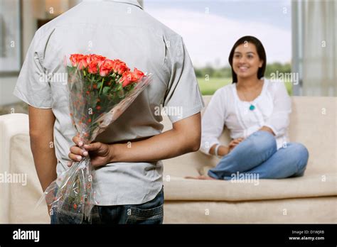 Man Holding Bunch Of Flowers Behind Back Stock Photo Alamy