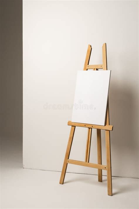 White Canvas On Wooden Easel And Copy Space On White Background Stock