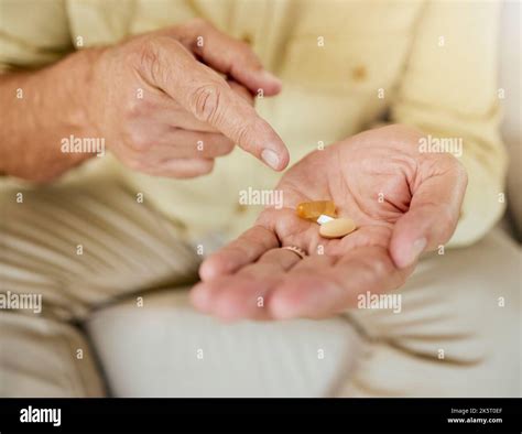 An Unknown Man Showing His Pills While Sitting At Home Unrecognizable