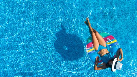 Beautiful Girl In Hat In Swimming Pool Aerial Top View From Above Woman