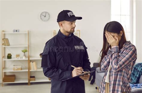 Weeping Woman Talking To Police Officer After Breaking Into House Stock