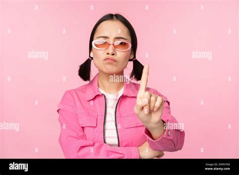 Image Of Serious Stylish Asian Girl In Sunglasses Showing Stop