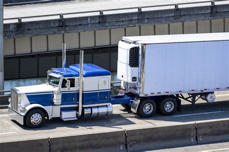 Blue And White Classic Big Rig Semi Truck With High Exhaust Pipes