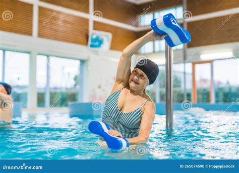 Senior Woman Doing Aerobic Water Exercises In The Swimming Pool Stock