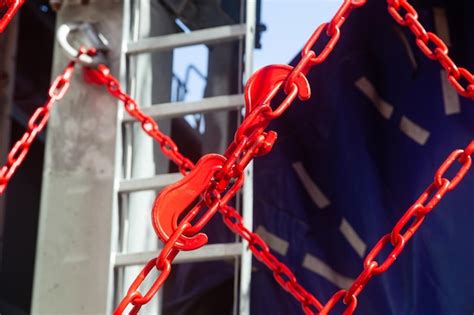 Premium Photo Many Red Chains With Hooks Are Fastened And Hold