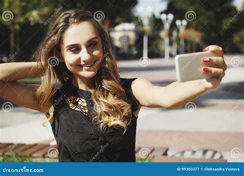 Portrait Of A Beautiful Young Woman Making Selfie On Smart Phone Stock