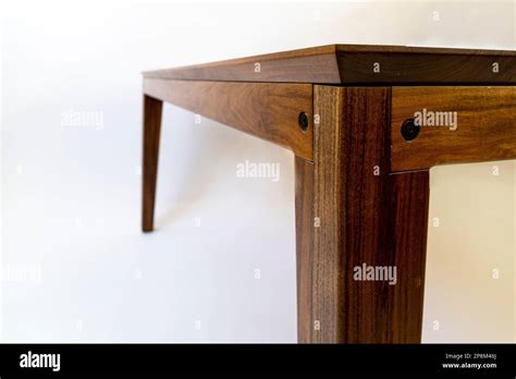 A Detail Of A Rectangular Wooden Table Isolated In A White Setting
