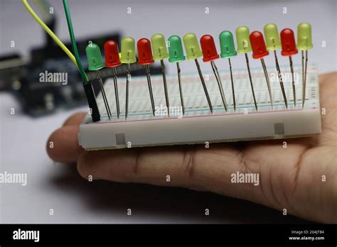 Series Of Light Emitting Diodes Connect To Breadboard Held In Hand Showing Inventor Laboratory