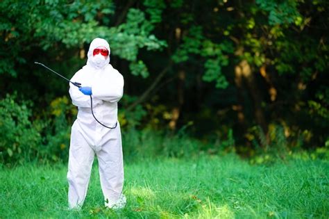 Premium Photo A Worker Sprays Pesticides On Trees Outdoors Tree Pest