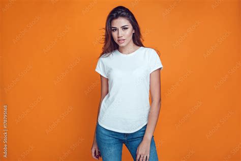 Sexy Woman In A White T Shirt On The Orange Background Mock Up Stock