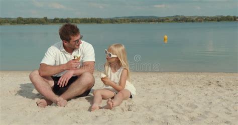 Caucasian Man And Daughter Tasting Ice Cream On The Beach Stock Footage