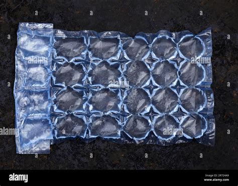Plastic Bag With Water For Ice On A Dark Background Blue Plastic