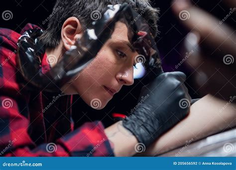 Tattoo Artist With Short Hair A Young Girl With Tattoos On Her Face And