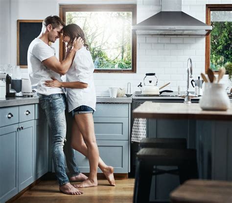 Hug Love Or Happy Couple In Kitchen For Romance Care Or Bonding