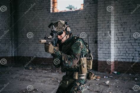 Soldier In Full Us Marsoc Equipment Entering Abandoned Building Aiming