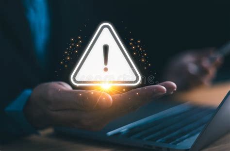 Businessman Using Computer Laptop With Triangle Caution Warning Sign
