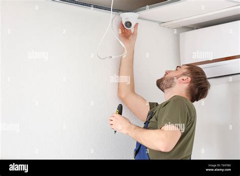 Electrician Installing Security Camera Indoors Stock Photo Alamy