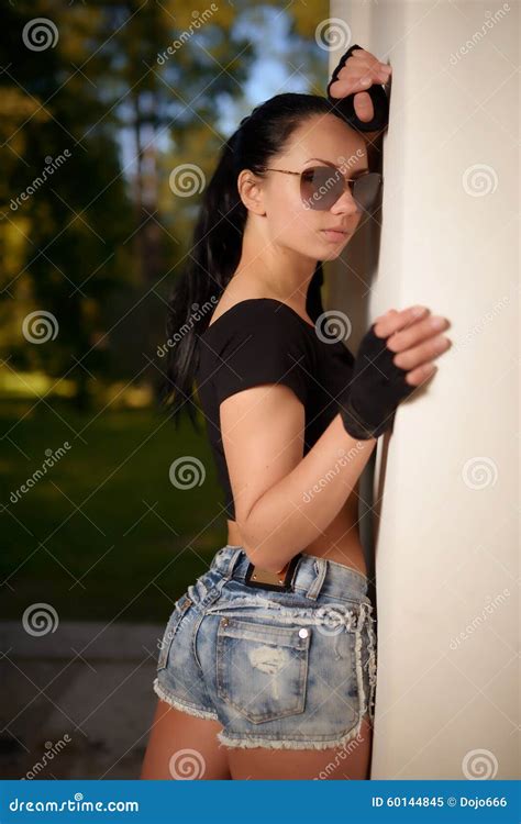 Portrait Young Swag Fashion Style Girl Posing At City Park Near Wall