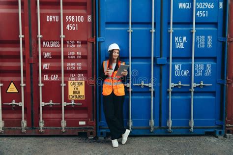 Female Engineer With Clip Folder In White Helmet And Vest Working In Container Terminal Port Or