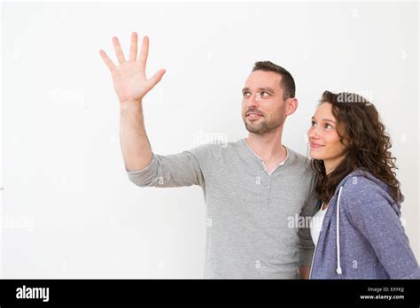 Couple Using Imaginary Touchscreen Interface Stock Photo Alamy